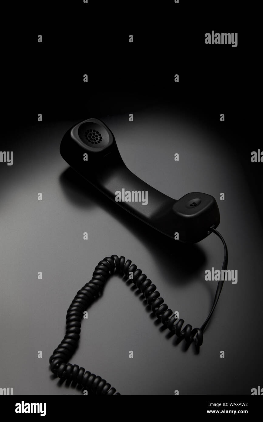 modern telephone receiver on dark background. concept technical support ...