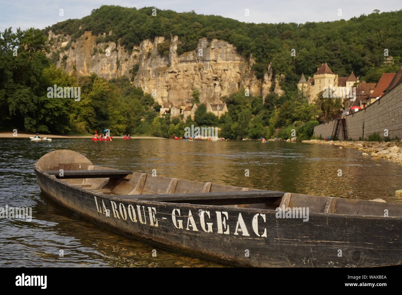 Rowing boat on the river with rock cliffs in the background Stock Photo ...