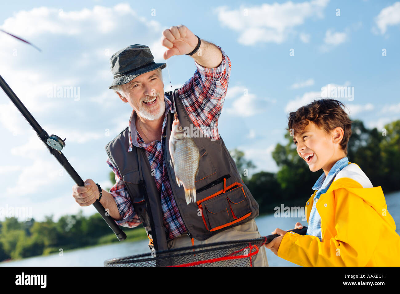 Grandson and grandfather feeling really happy after catching fish Stock ...