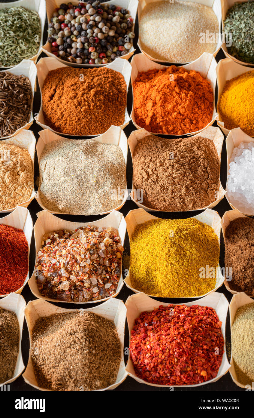 Spices and herbs in bowls in natural light. Condiments and flavors ...