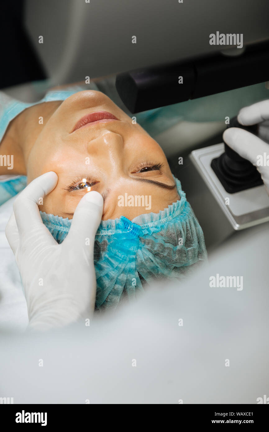 Professional skilled doctor touching his patients eye Stock Photo - Alamy