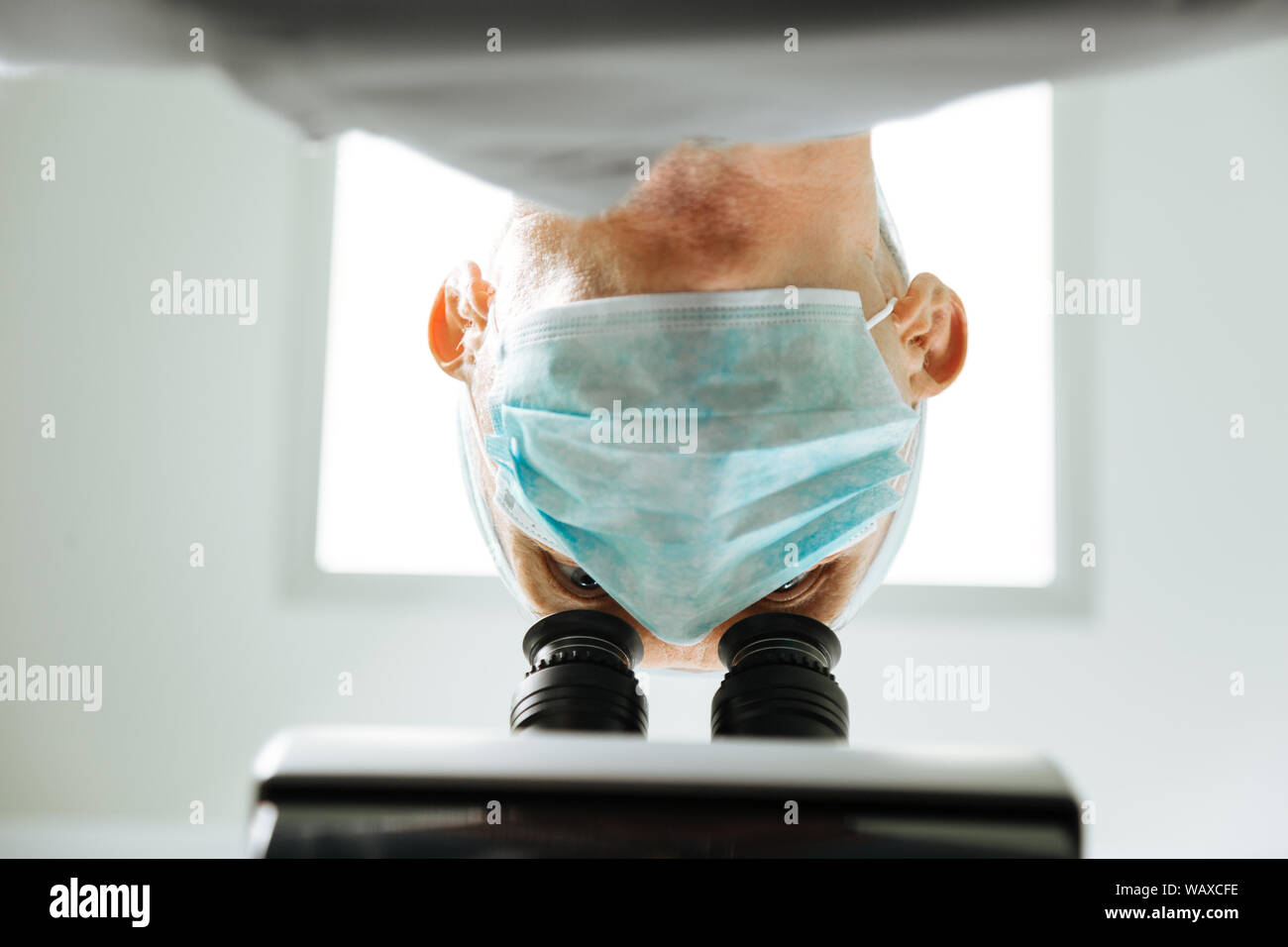 Low angle of a doctor in a facial mask Stock Photo - Alamy
