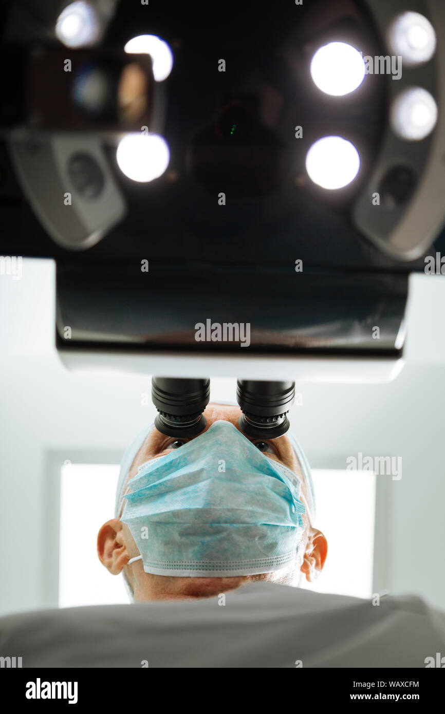 Low angle of a serious professional eye doctor Stock Photo - Alamy