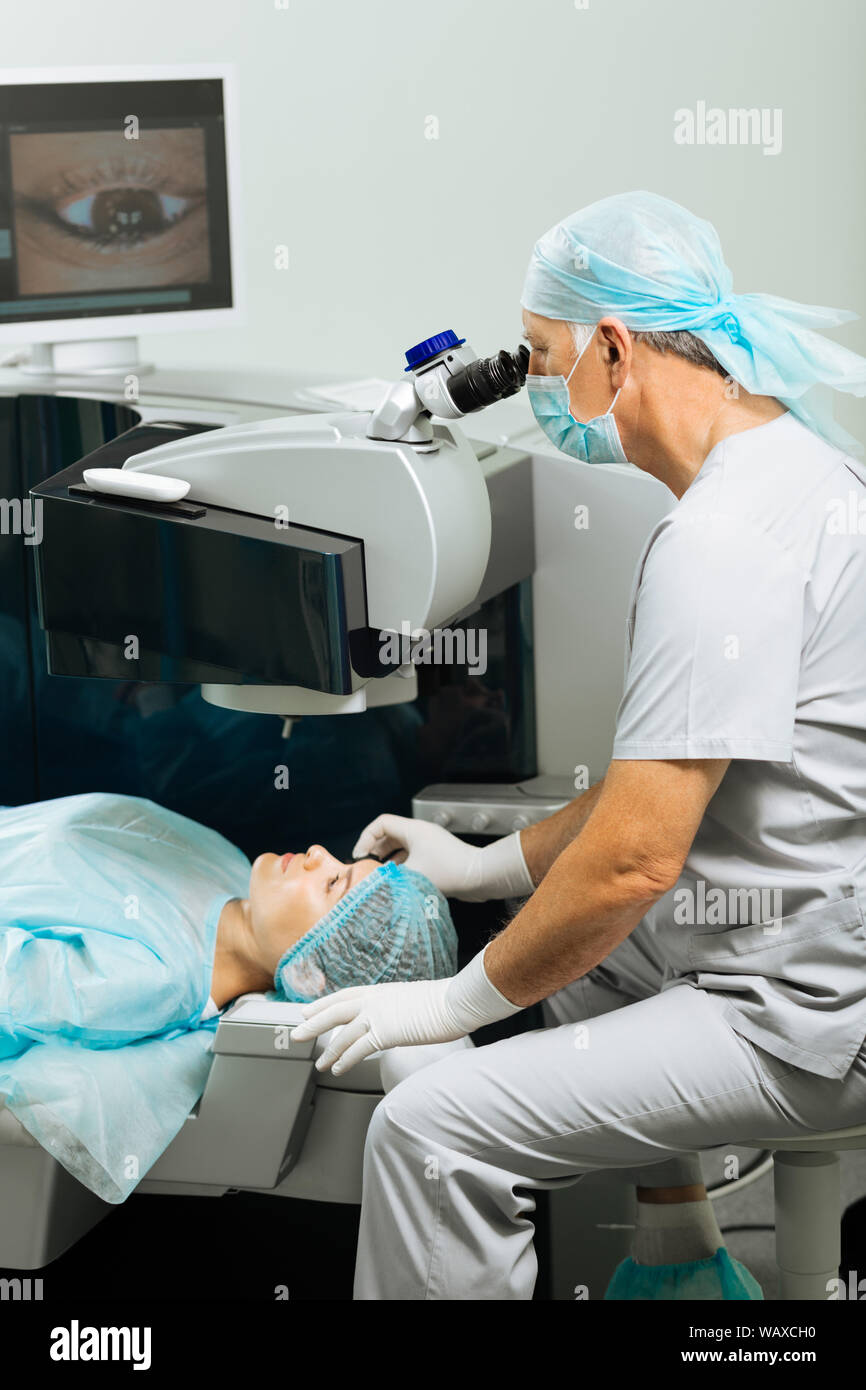 Pleasant nice woman having a vision control test Stock Photo - Alamy