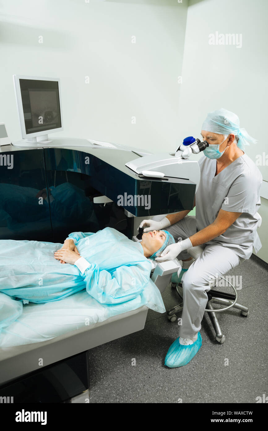 Professional serious doctor checking his patients vision Stock Photo ...