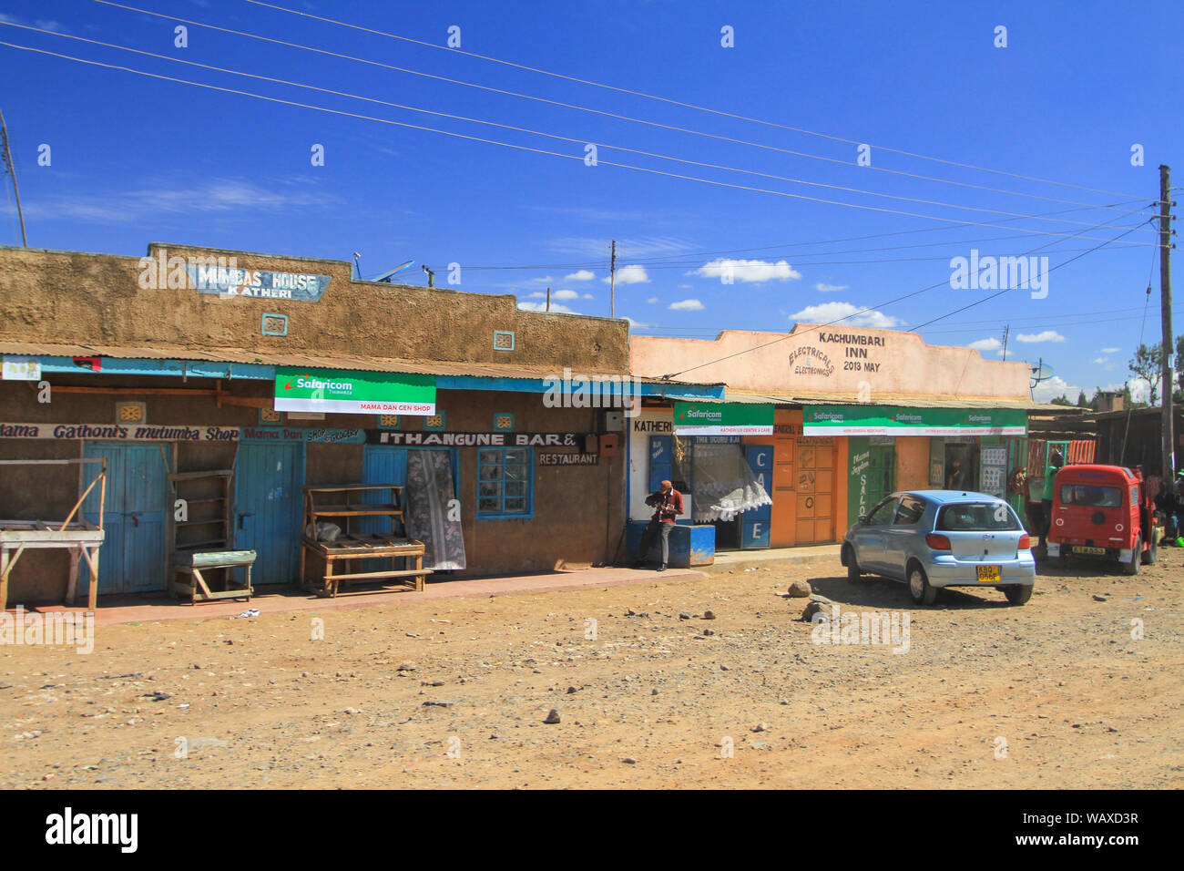 Village street, Kenya, Africa. Local people outside small shops ...