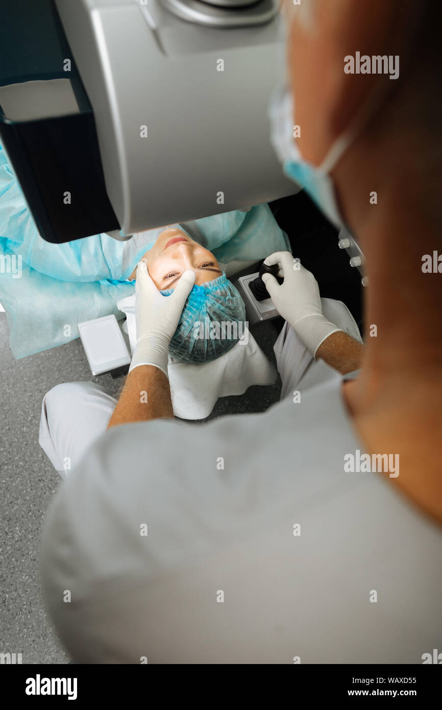 Professional male doctor checking his patients eyes Stock Photo - Alamy