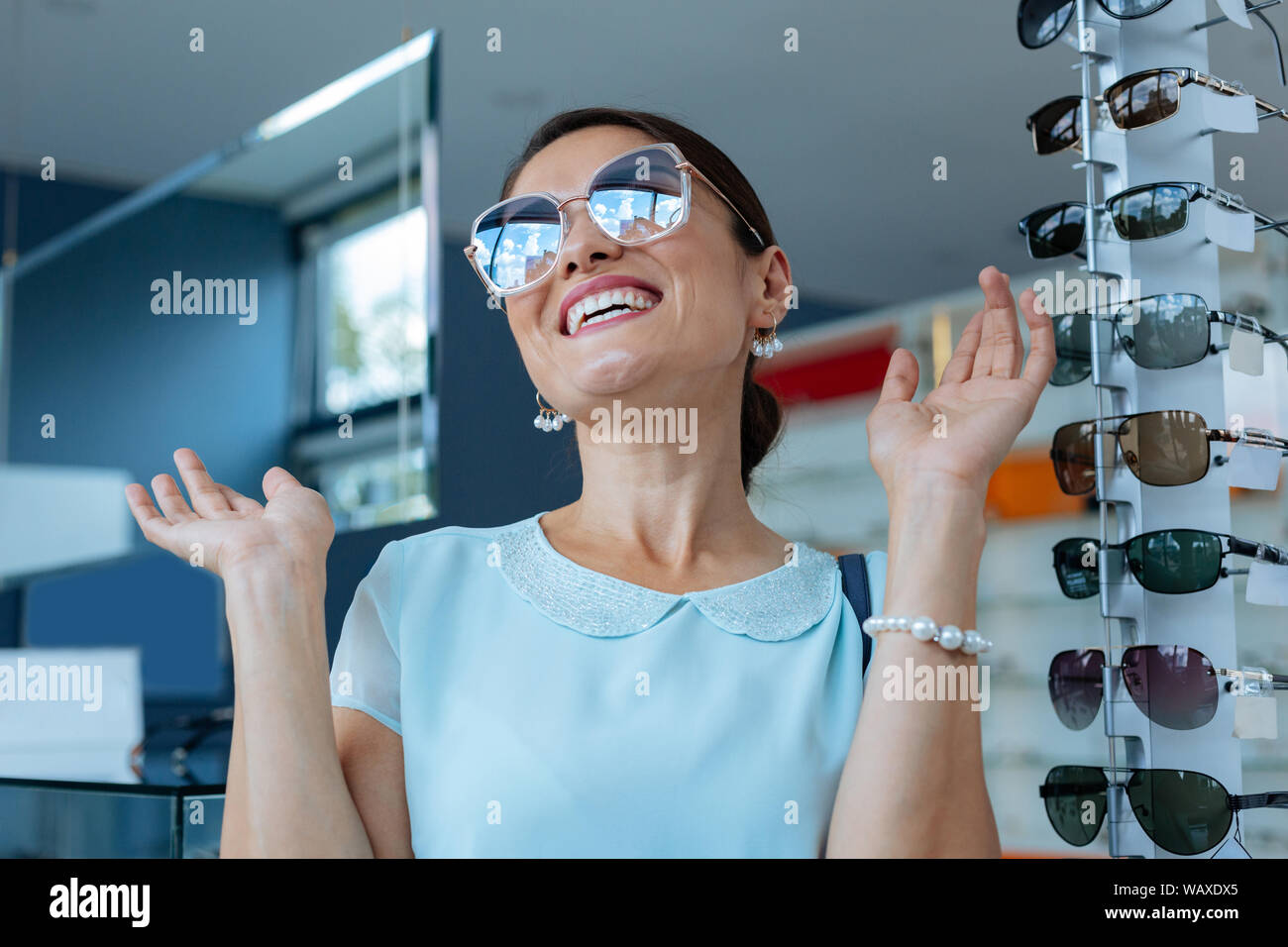 Woman trying on glasses hi-res stock photography and images - Alamy