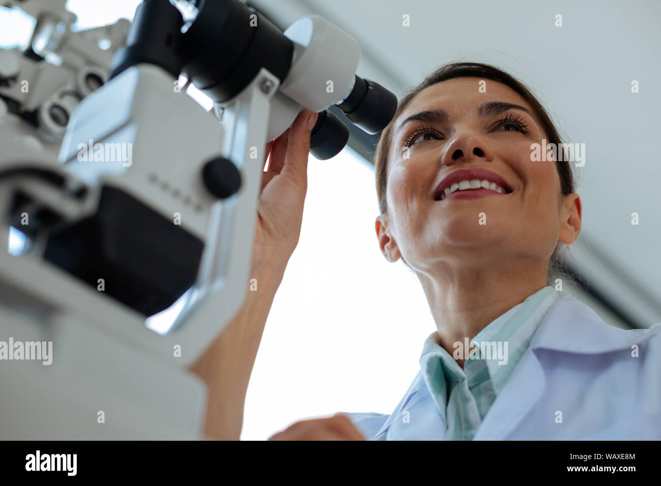 Low angle of a positive cheerful doctor Stock Photo - Alamy