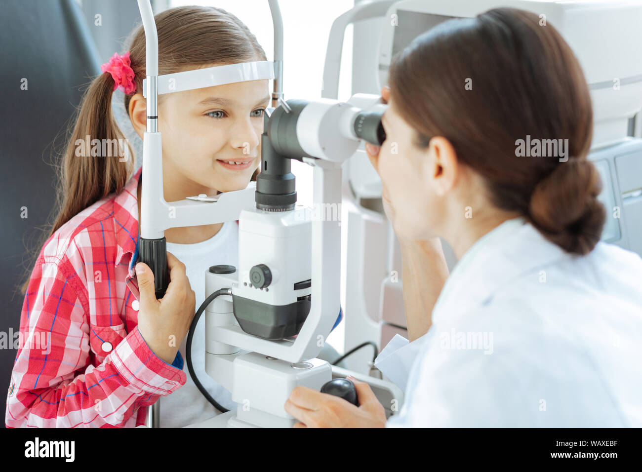 Nice pretty girl having her eyesight checked Stock Photo - Alamy