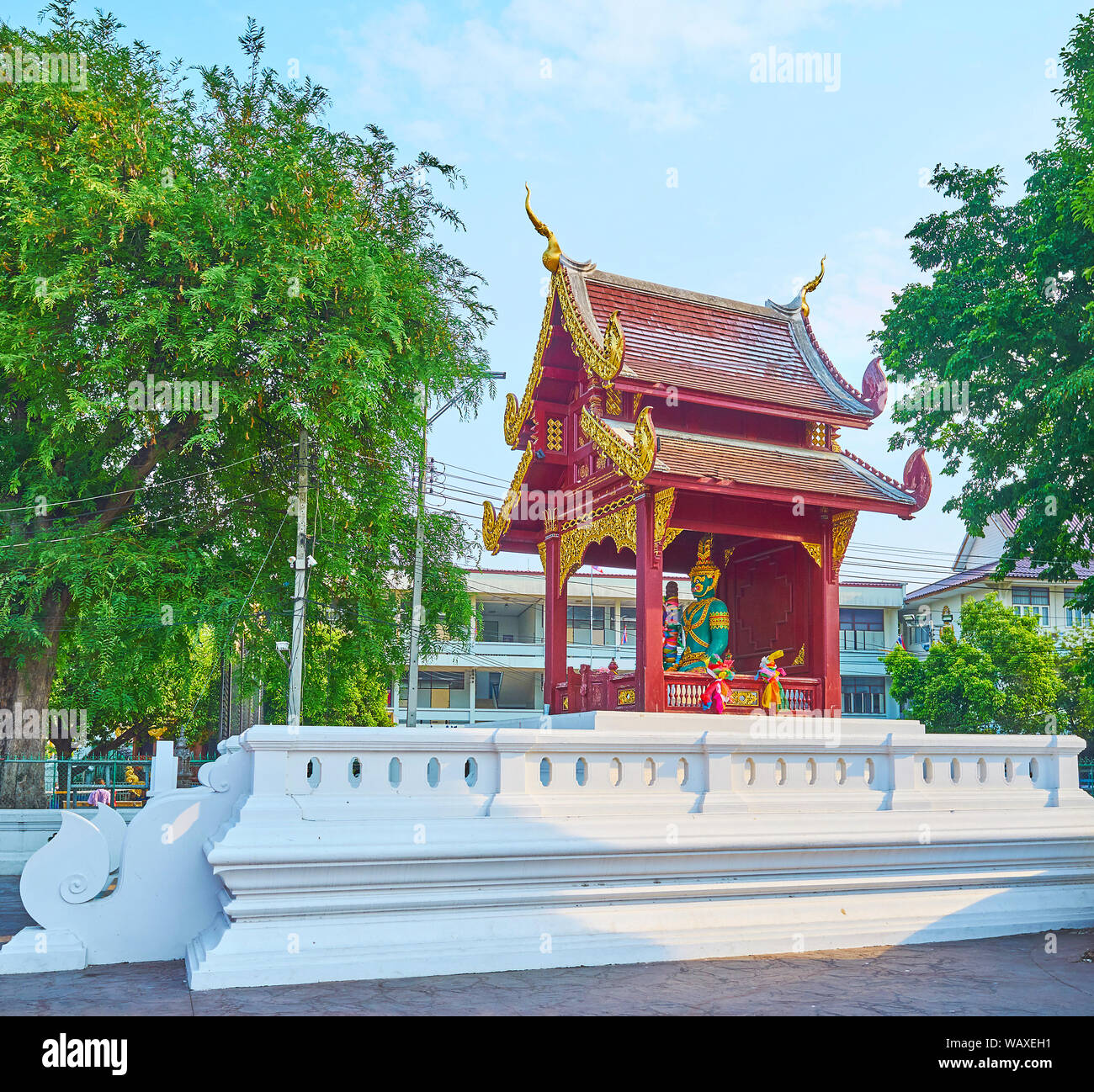 Exquisite wooden mondop with slender pillars houses Yaksha statue, this ...