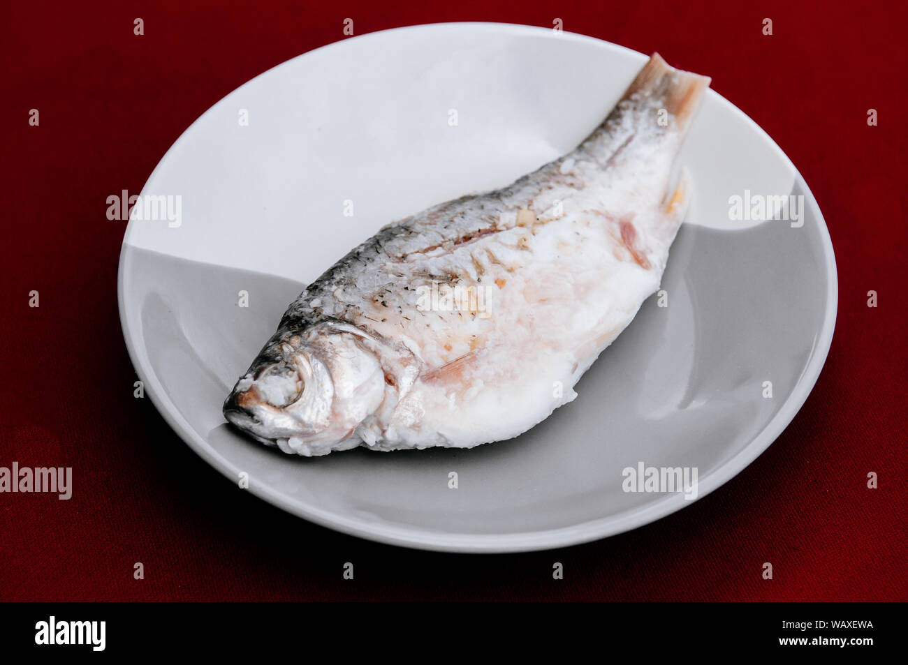 Thai Fermented salty and sour fish with rice or Pla Som on dish on red ...