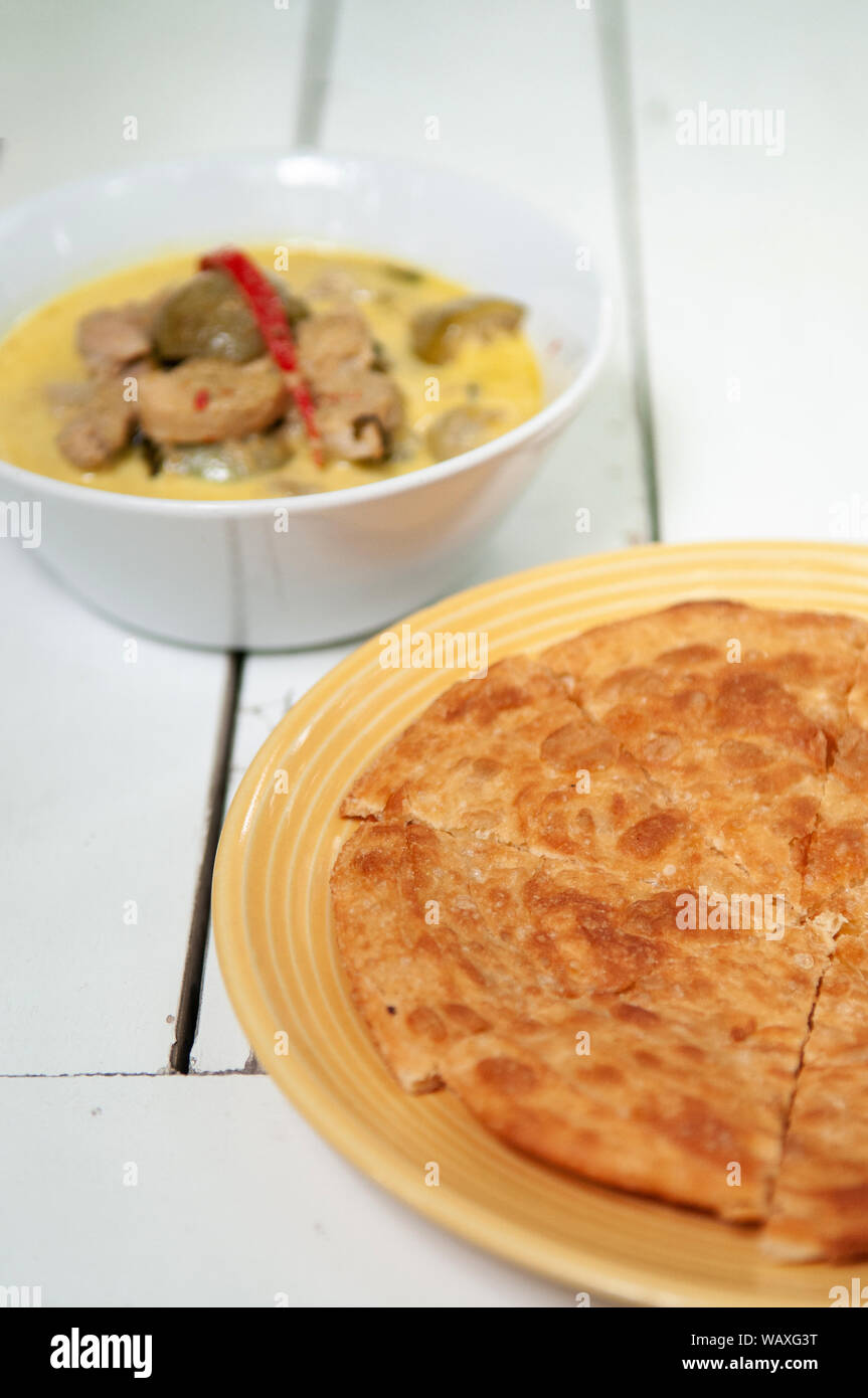 Delicious Indian roti with spicy creamy Thai green curry dishes on ...