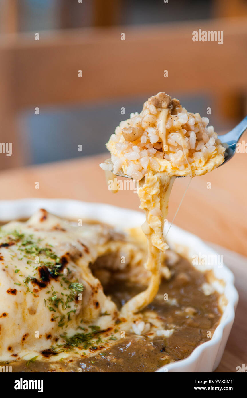 Japanese Kare Omu rice, Japanese omelette rice with curry on spoon ...
