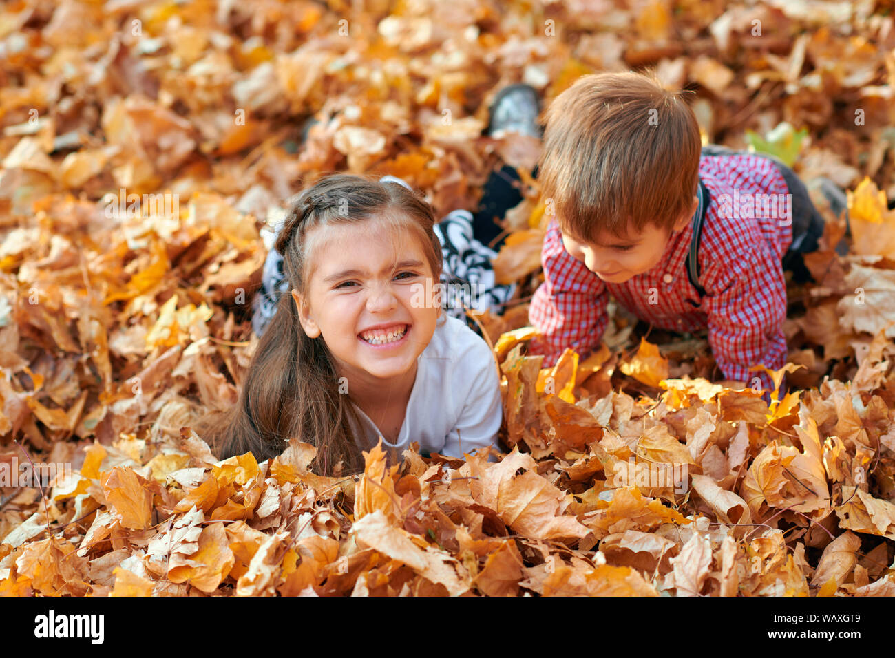 Happy children playing, posing, smiling and having fun in autumn city ...