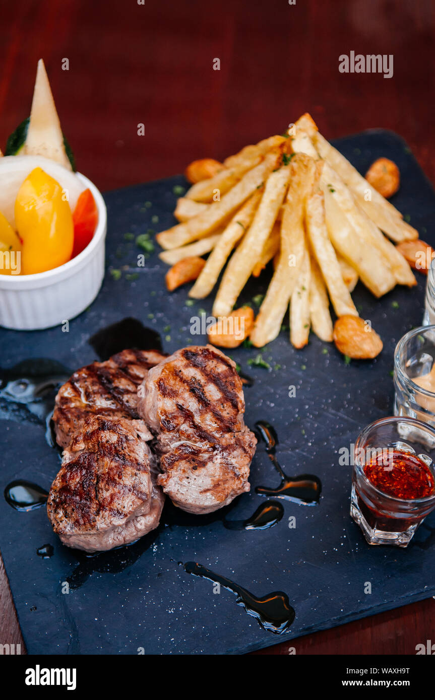 Nice peices of beef tenderloin steak with freach fried potatoes and ...