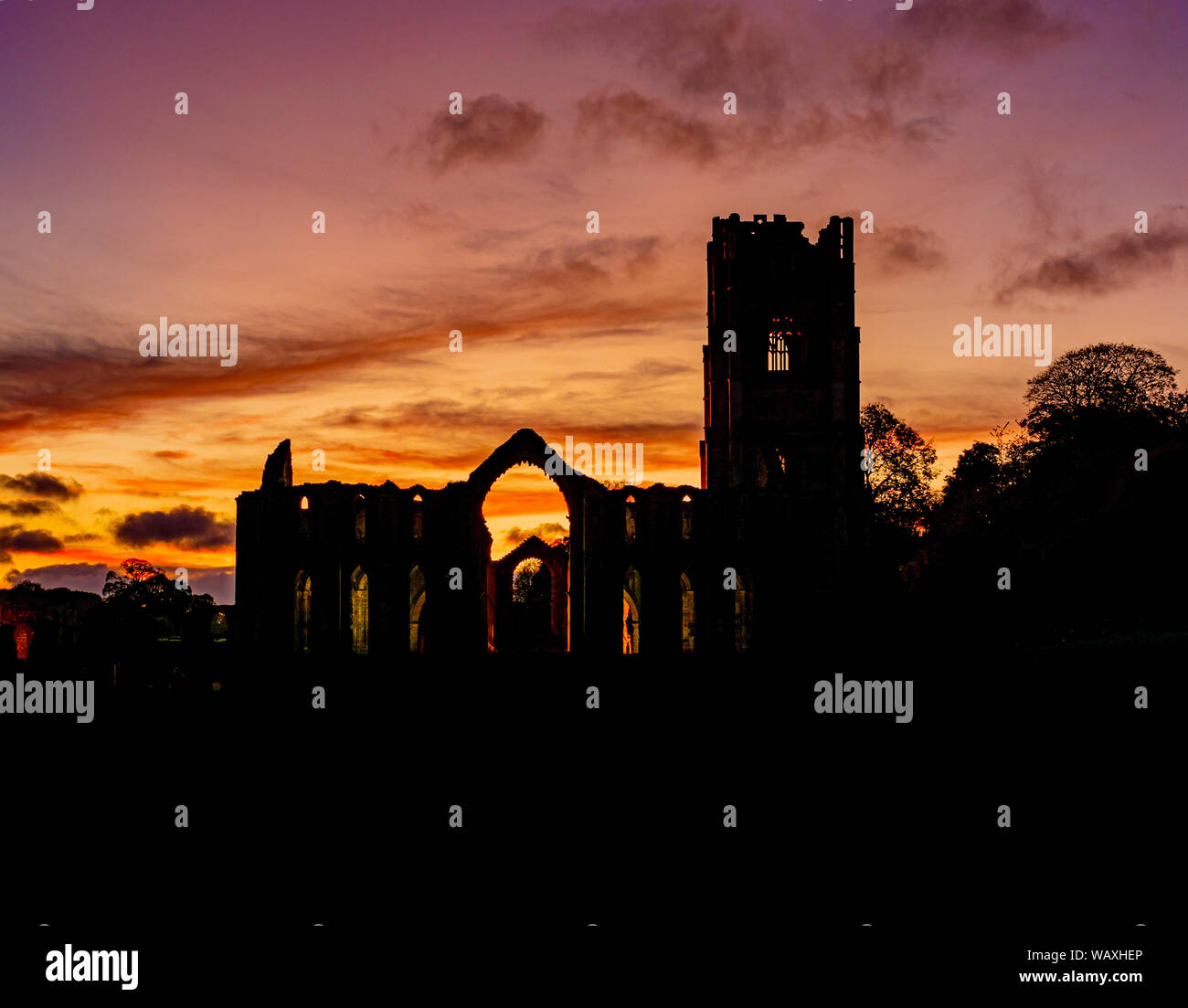 Sunset at the ruins of Fountains Abbey at Studley Royal Water Garden ...