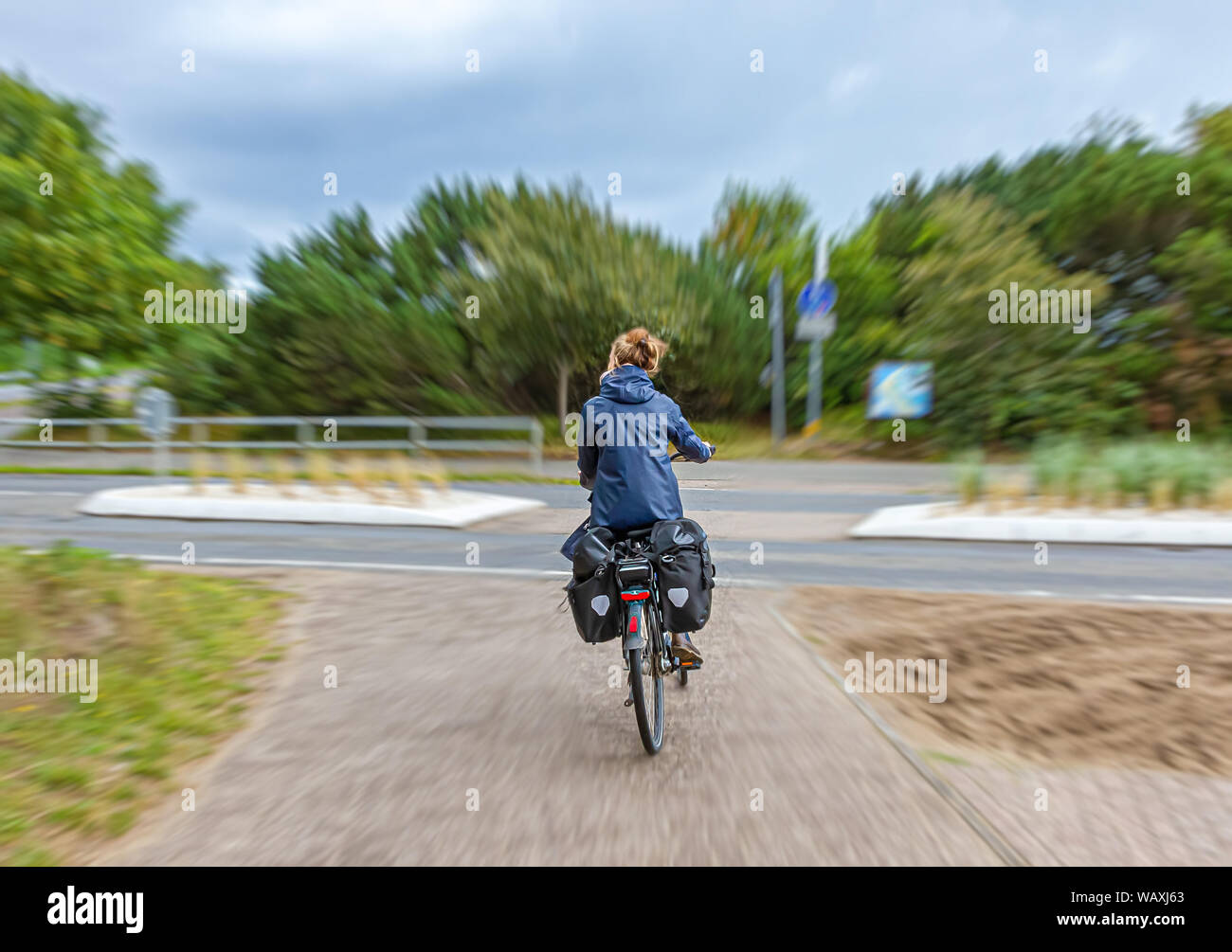 Woman driving bike street hi-res stock photography and images - Alamy