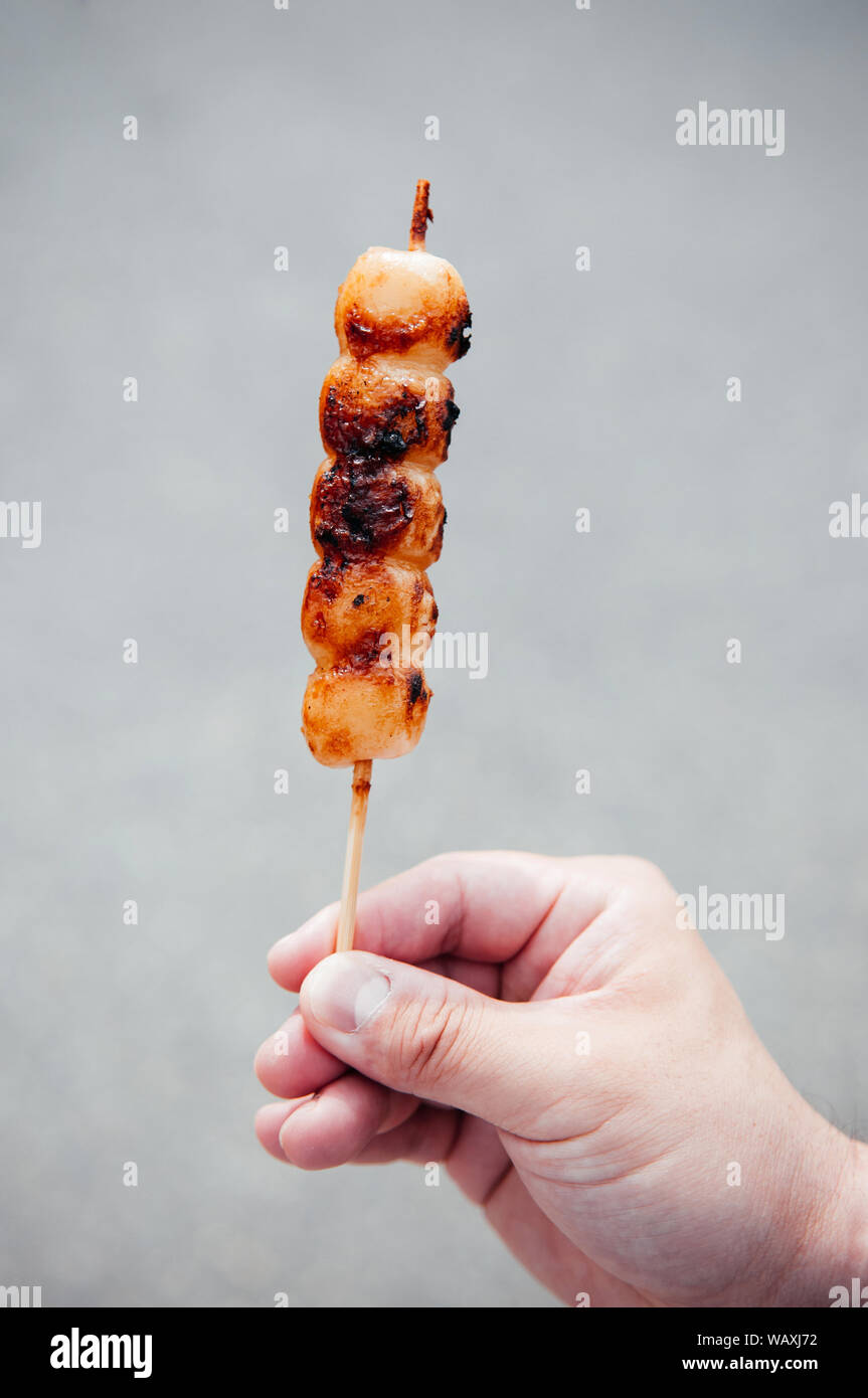 Japanese street food snack grilled Mitarashi Dango skewer with salty ...