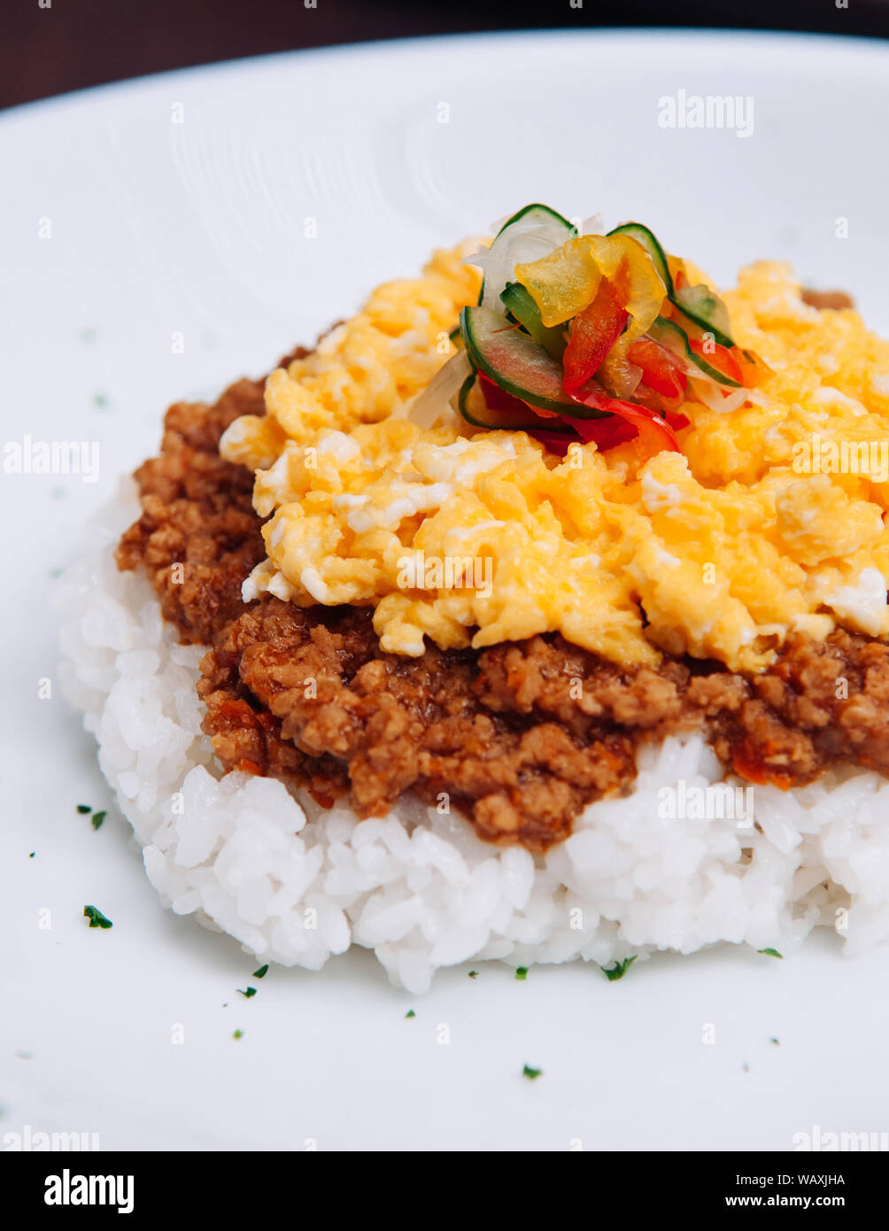 Japanese spicy Tan Tan pork over steamed rice with medium cooked ...