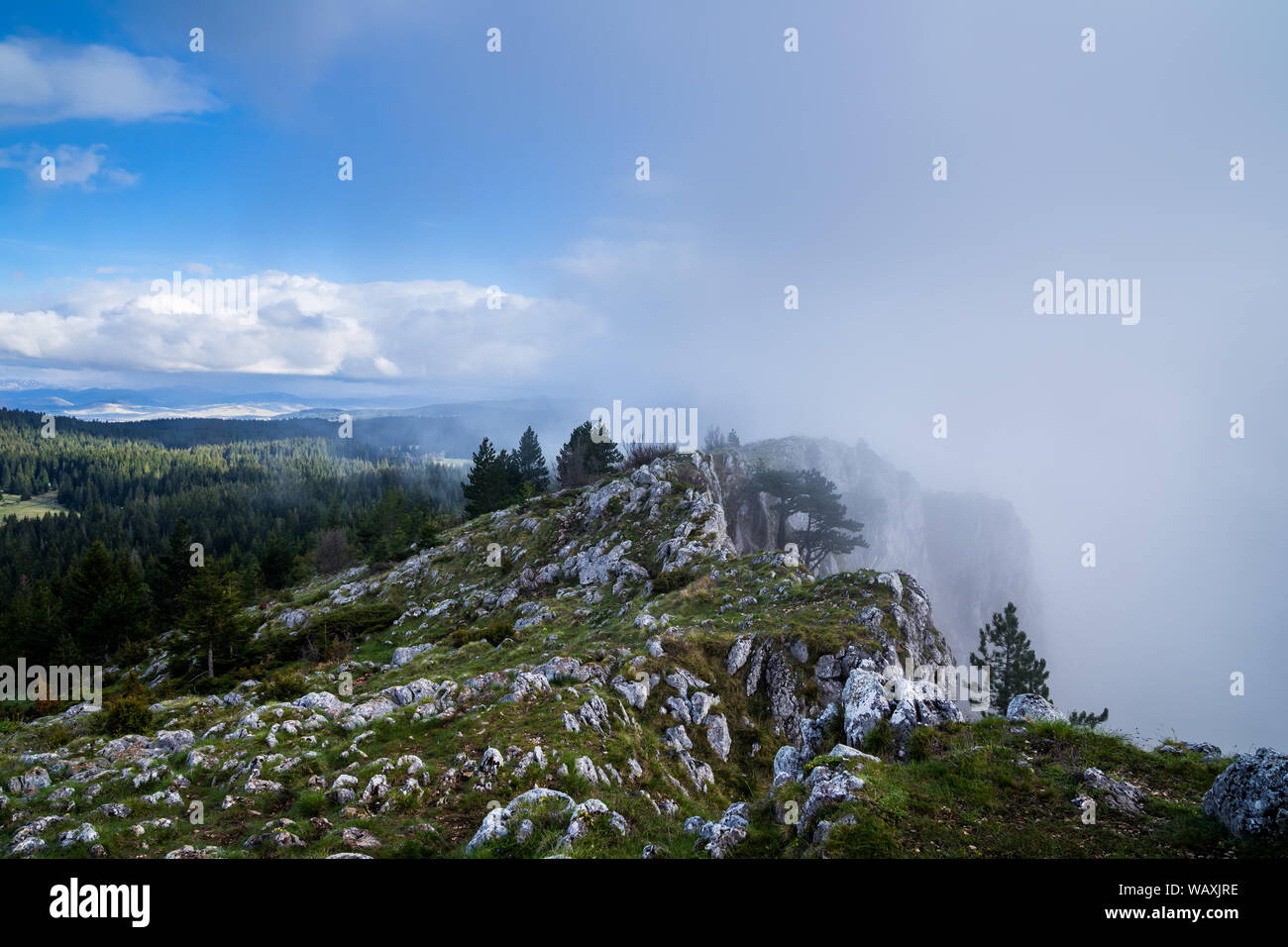 Montenegro, Weather contrast of blue sky versus foggy rain clouds ...