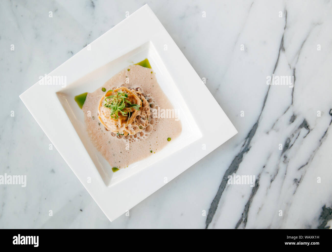 Spinach and ricotta stuffed vegetarion Tortellini Ravioli with white ...