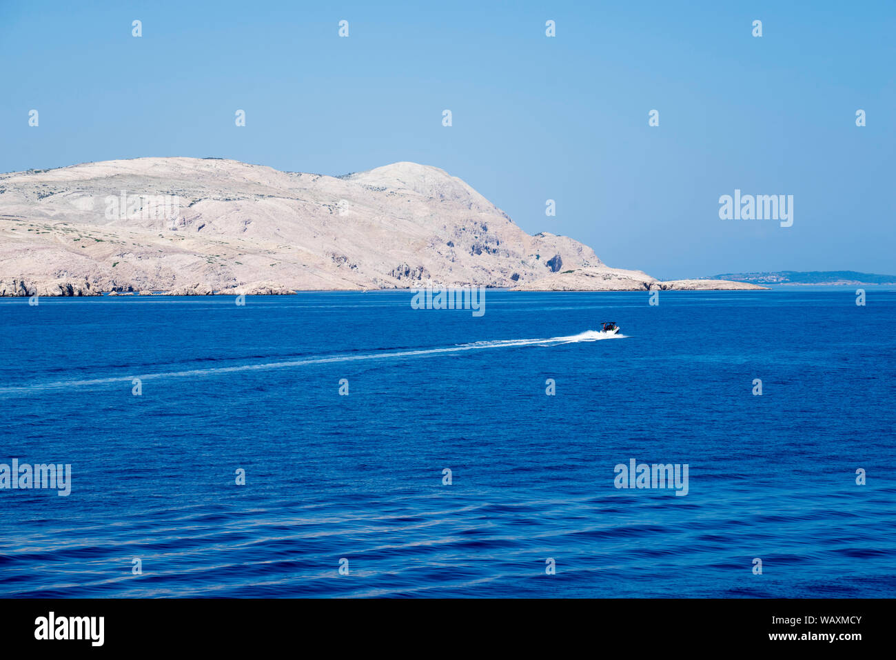Boats, blue sea, rocks Stock Photo - Alamy