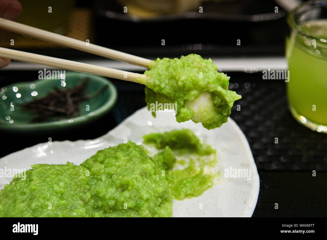 Zunda mochi or Mochi with green soybeans paste picking with chopsticks ...