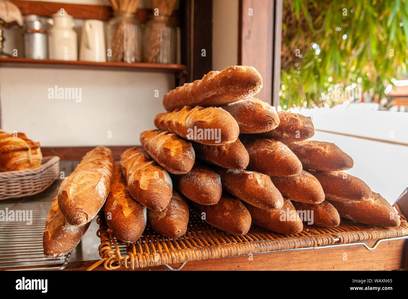 Big pile of beautiful French Baguette wheat bread in small local bakery ...