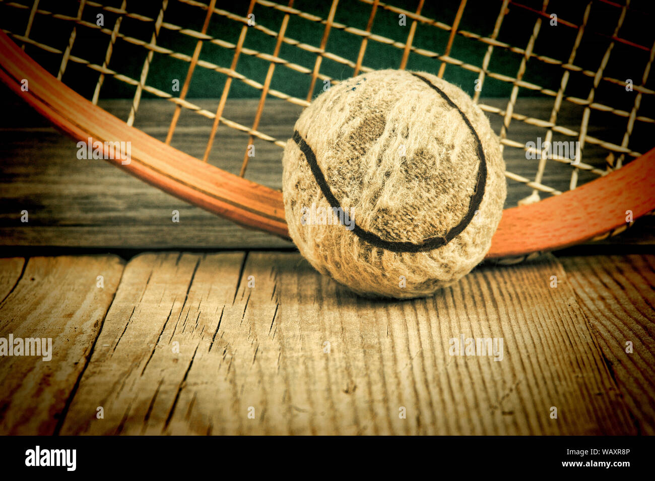 old tennis ball and racket on a wooden floor Stock Photo - Alamy