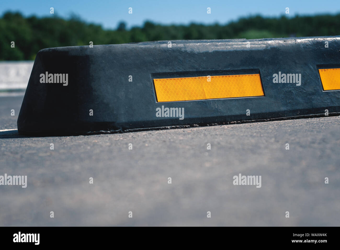 Modern rubber barrier for cars in summer parking. Close-up Stock Photo ...