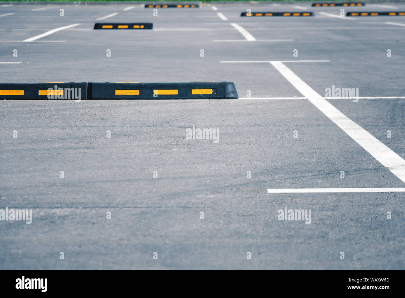 Modern rubber barrier for cars in summer parking Stock Photo - Alamy