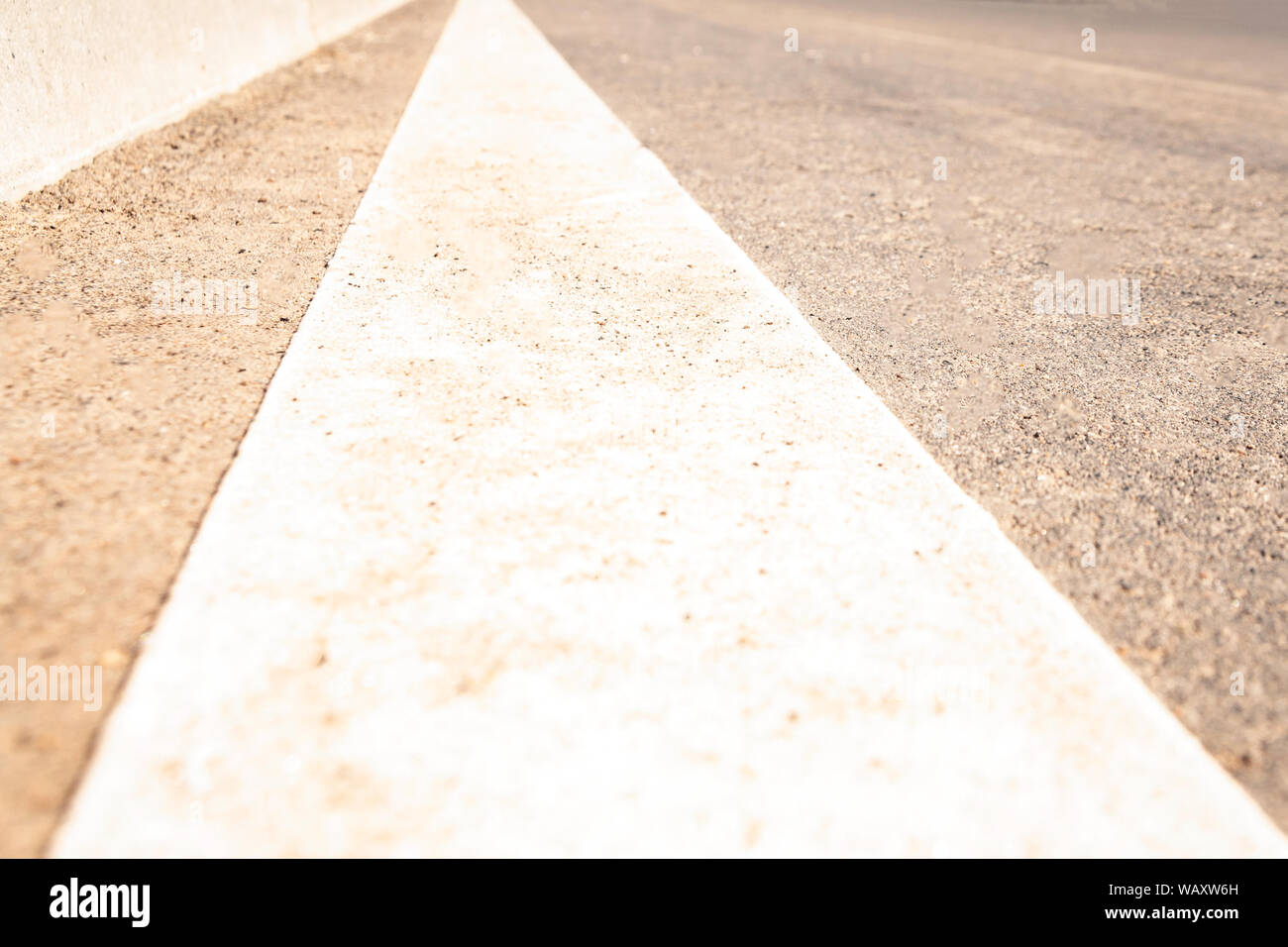 Road with a white marking line. Close-up Stock Photo - Alamy