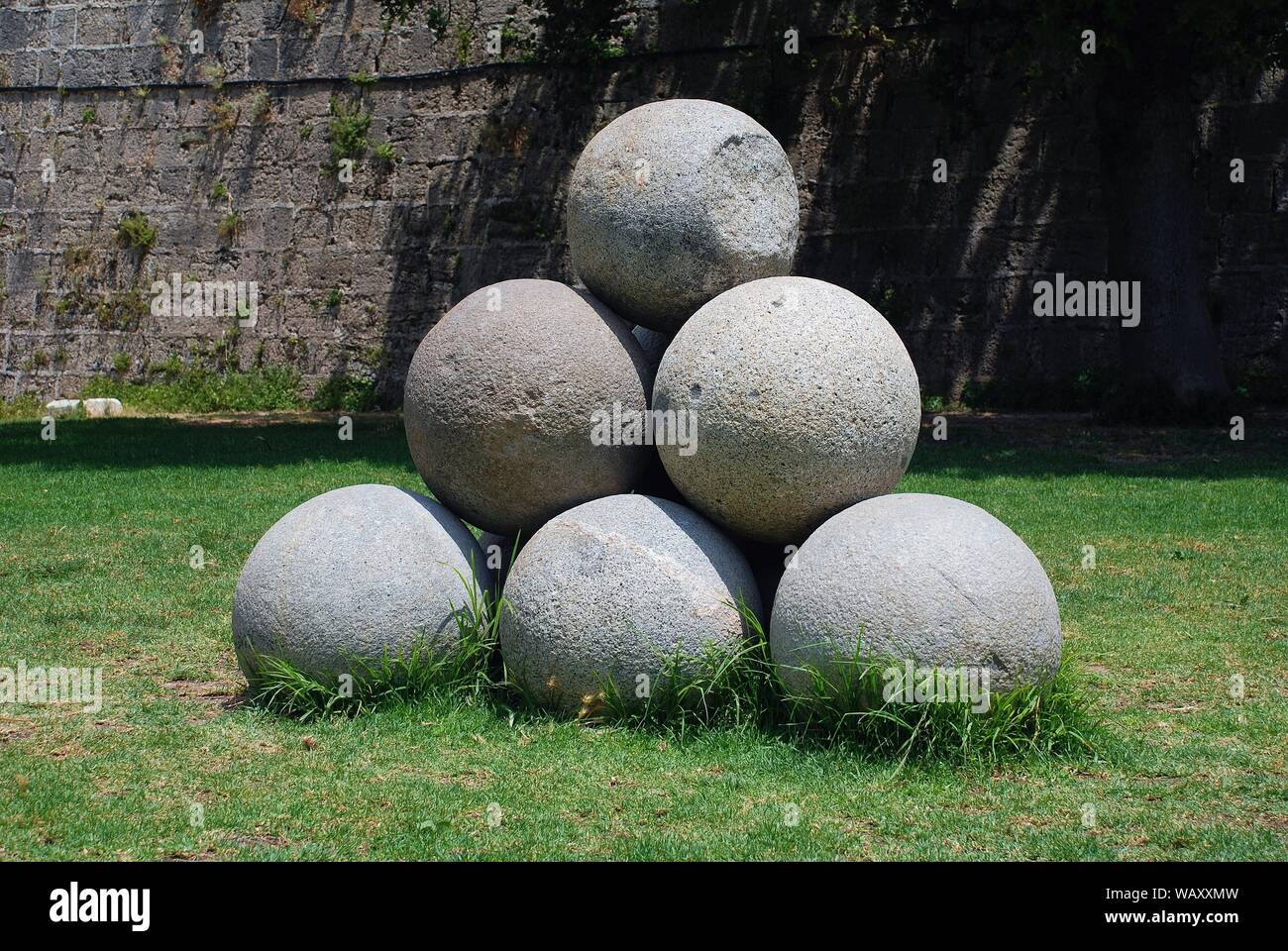 A pile of old stone cannonballs in the drained moat surrounding the ...