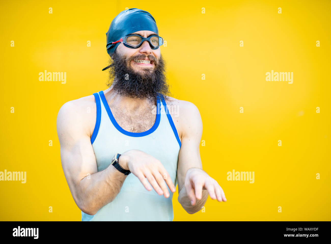 Portrait of a weird, old-fashioned swimmer dressed in 80s style with ...