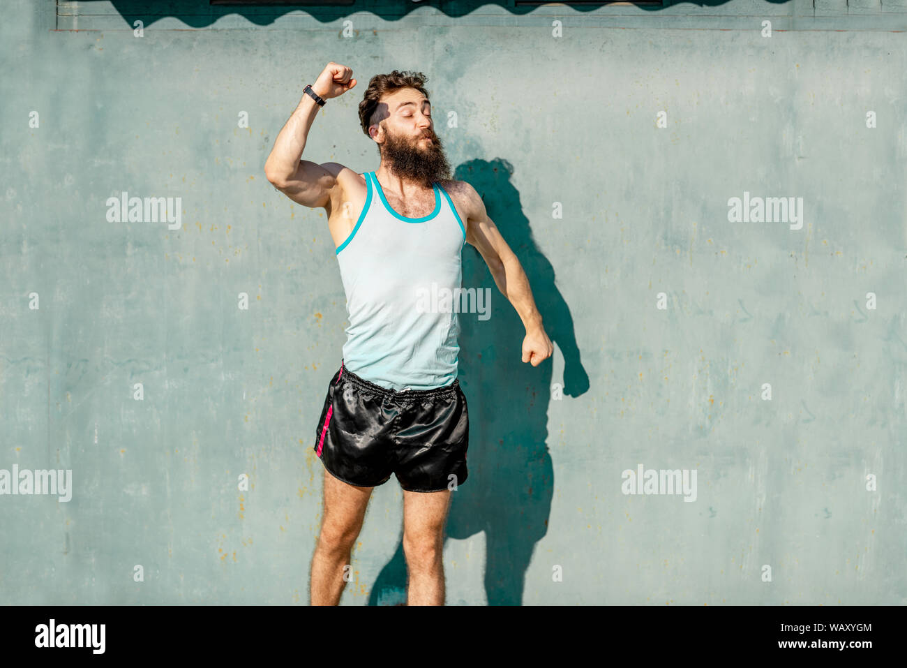 Portrait of an energetic, old-fashioned athlete dressed in 80s style ...