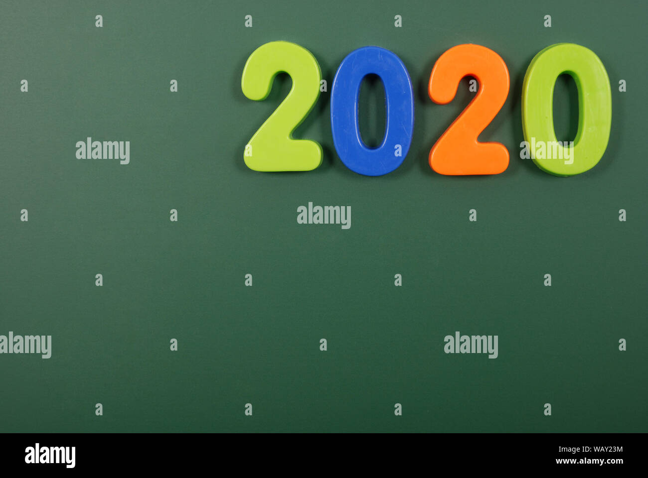 2020 year written in bright plastic magnetic letters stuck on a ...