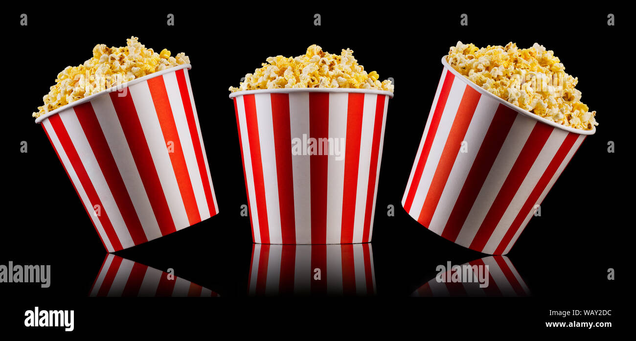 Set of paper striped buckets with popcorn isolated on black background ...