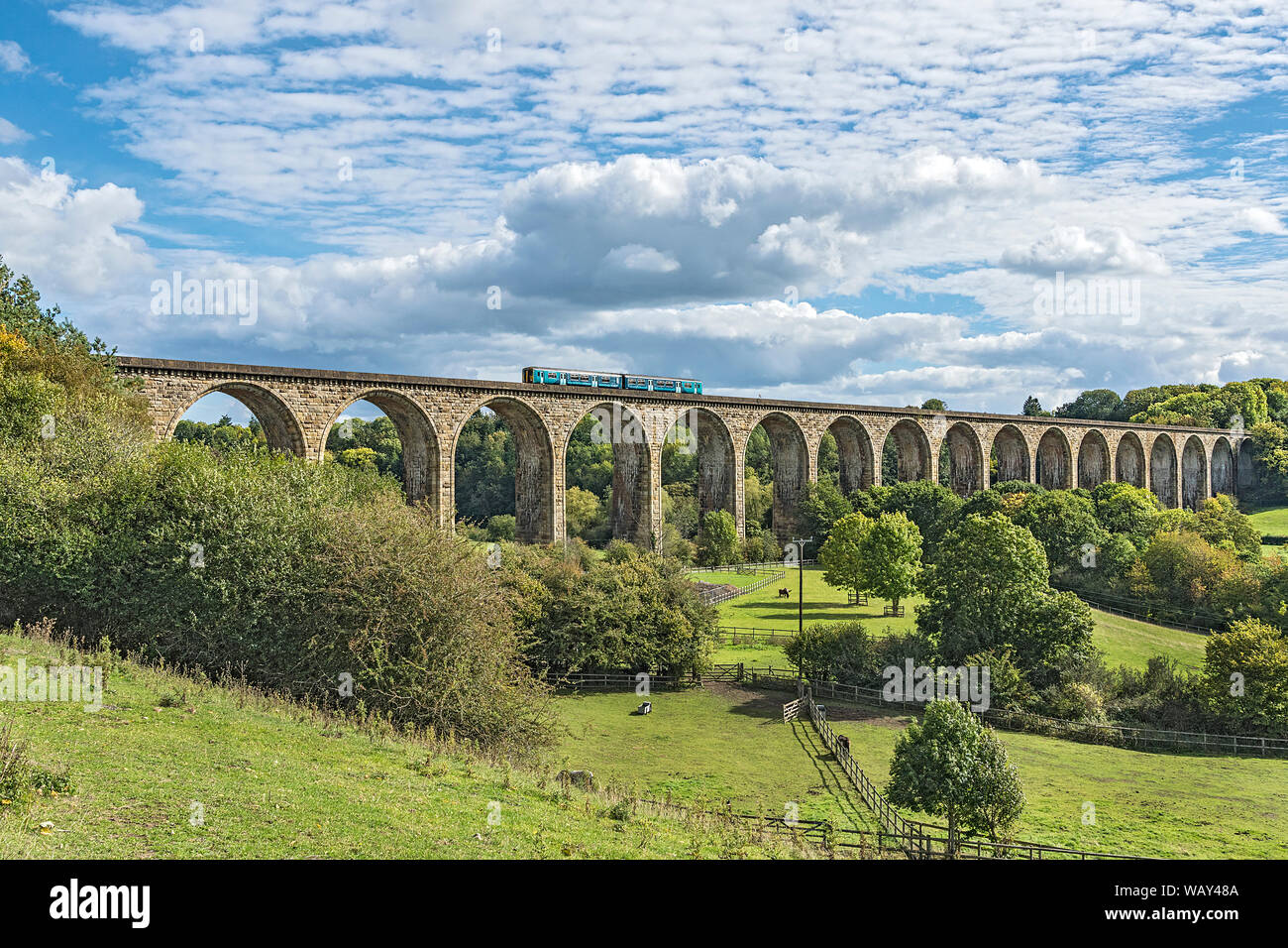 Train crossing the viaduct over the River Dee in the Vale of Llangollen ...