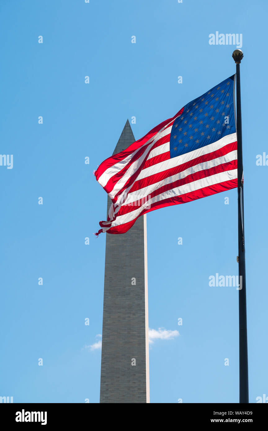 US flag flying from a pole with Washington Monument in background Stock ...