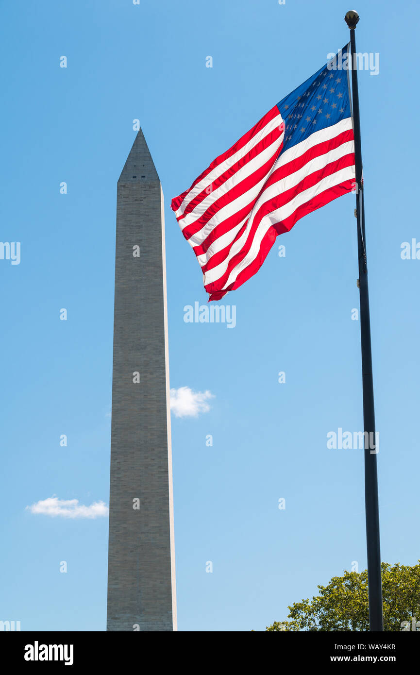 US flag flying from a pole with Washington Monument in background Stock ...
