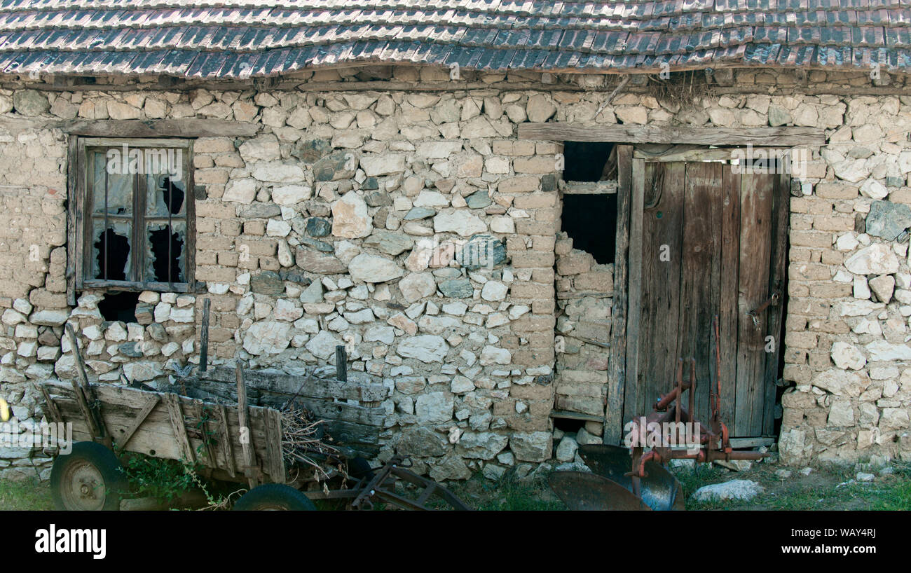 Old barn ruins. Ruins of abandoned farm building. Stone house in decay ...