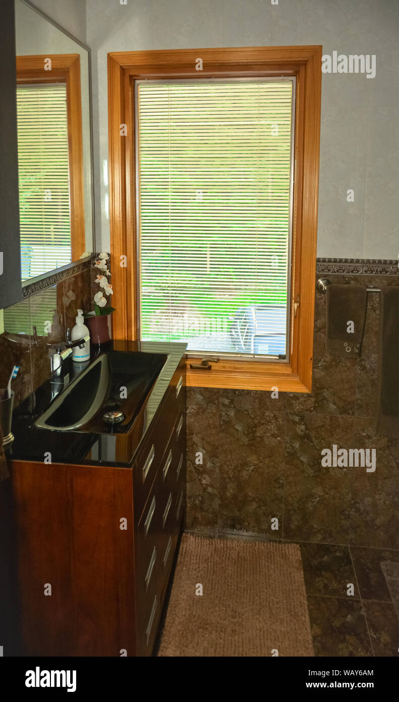 Black wash-basin at the window in a bathroom of luxury house Stock ...
