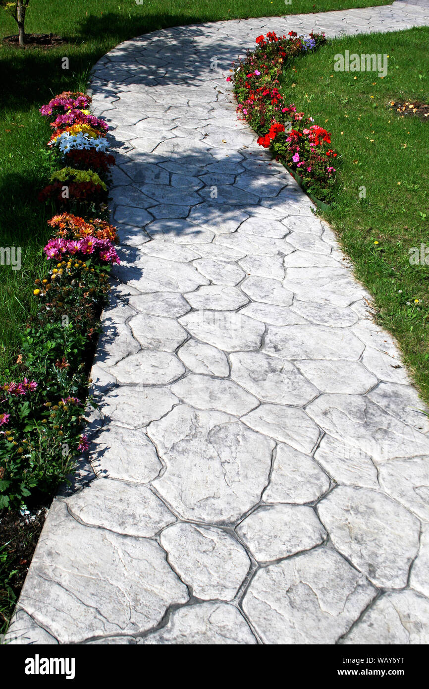 Pathway in garden with flowers and grass Stock Photo - Alamy