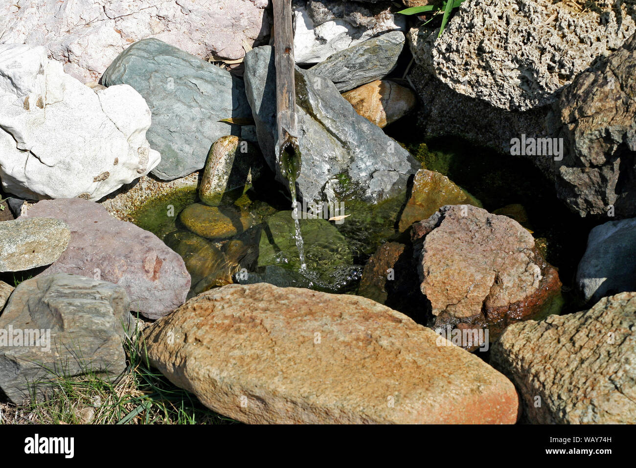 Zen spring water with bunch of rocks Stock Photo - Alamy