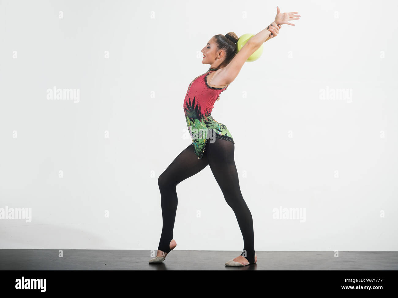 acrobatics of woman with ball in sportswear. acrobatics training ...