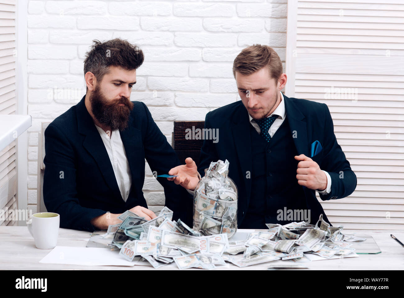 Business partners, businessmen at meeting in office. Cash issues ...