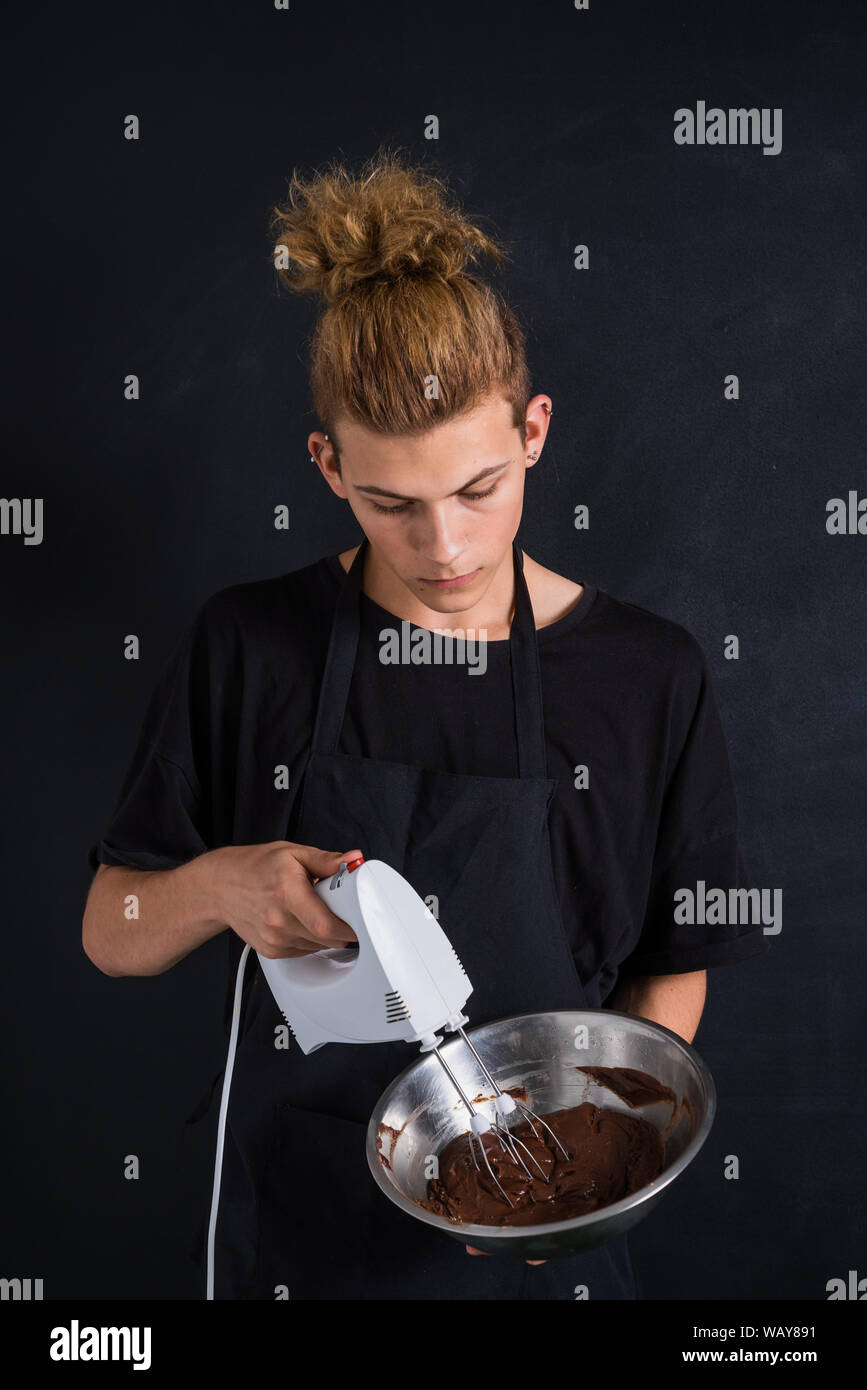 Men in black t-shirt mixing cream for a cake Stock Photo - Alamy