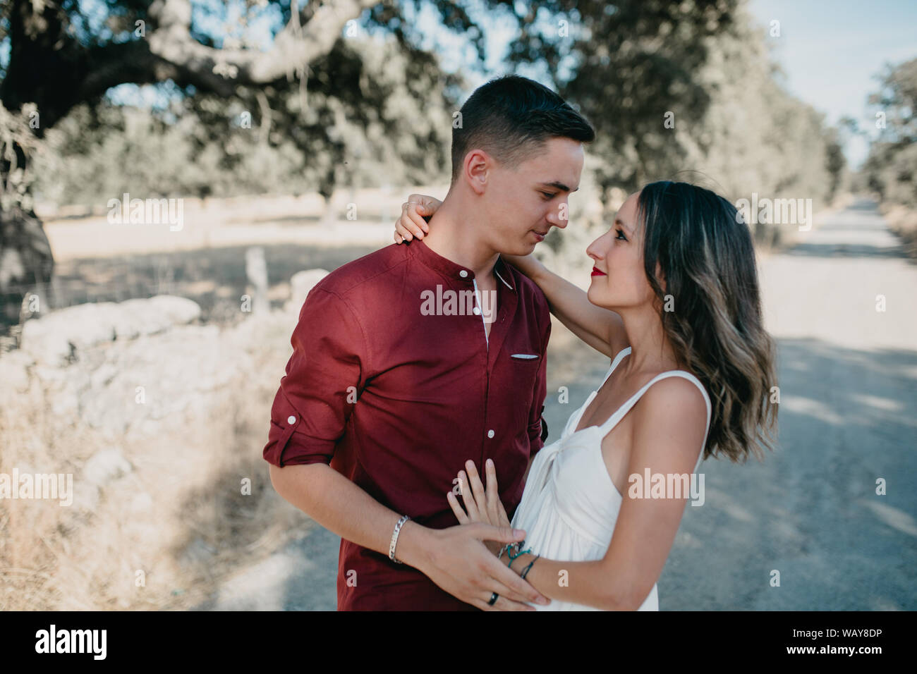 girlfriend hugs boyfriend while looking at him with love Stock Photo ...