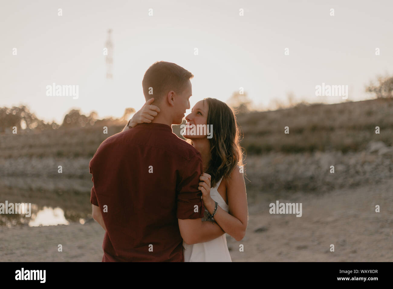 Kiss couple in love sunset hi-res stock photography and images - Alamy